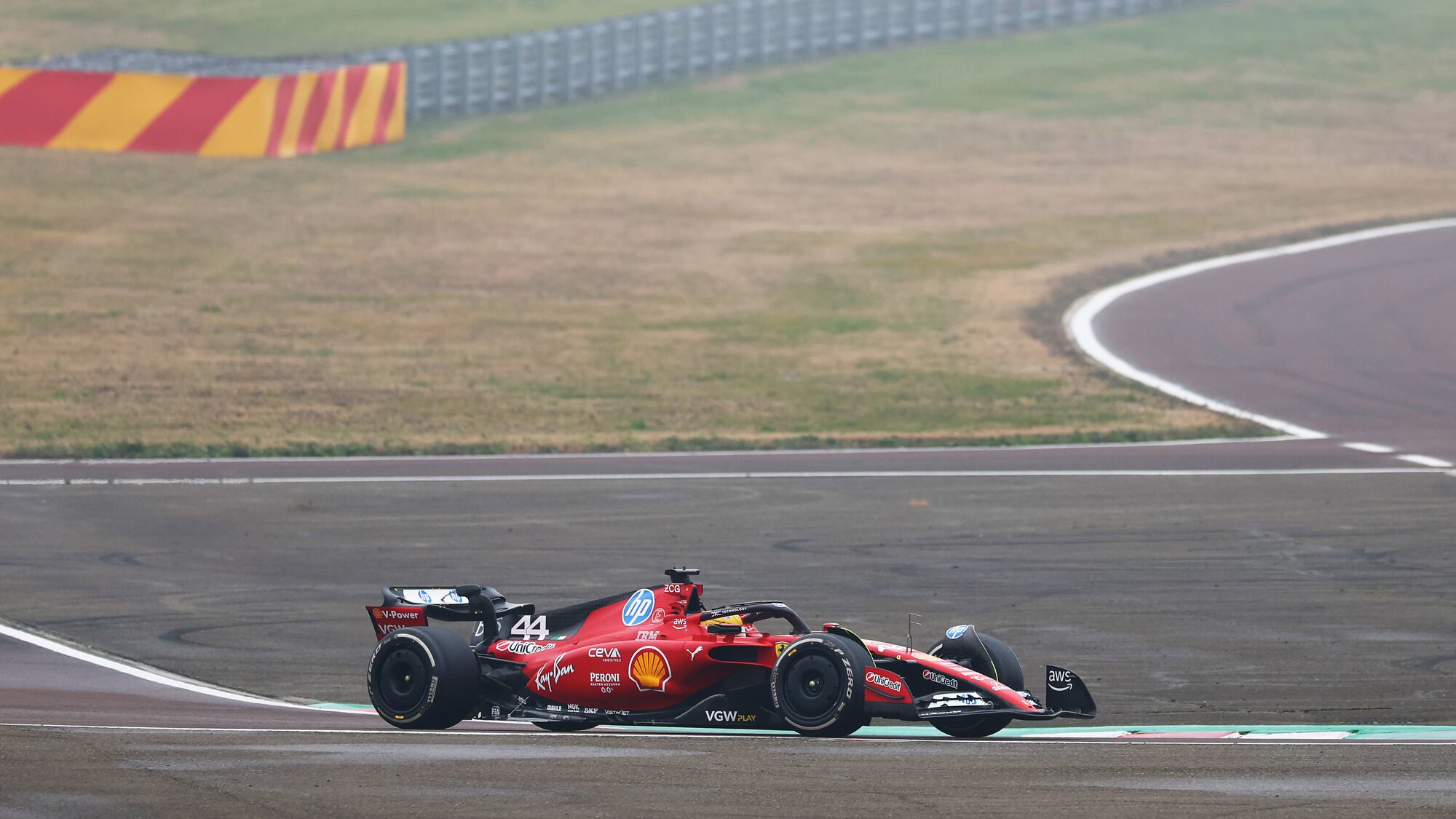F1 champion Lewis Hamilton makes iconic first appearance in Ferrari red ...