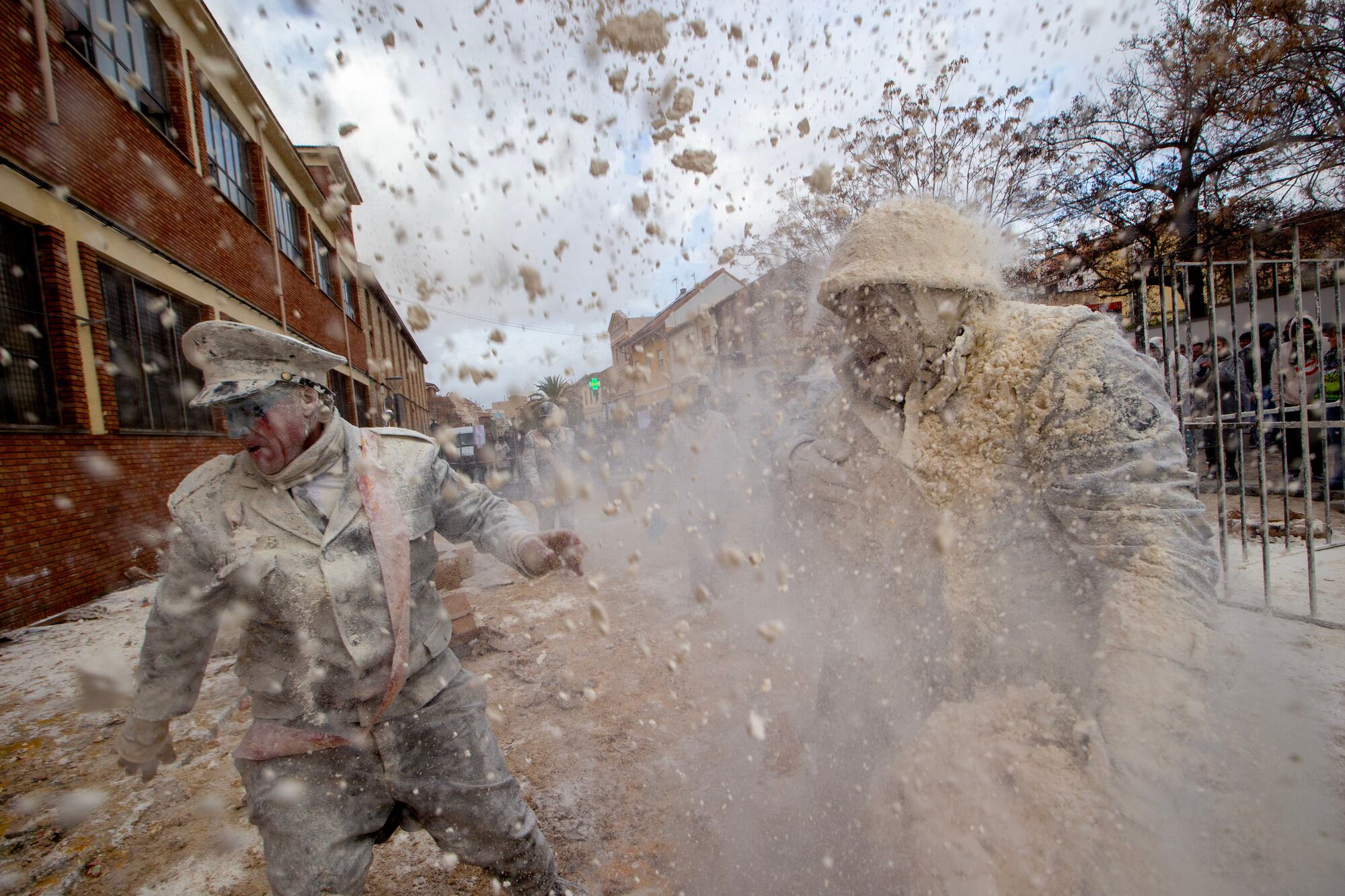 Revellers battle with flour and eggs during the Els Enfarinats festival ...